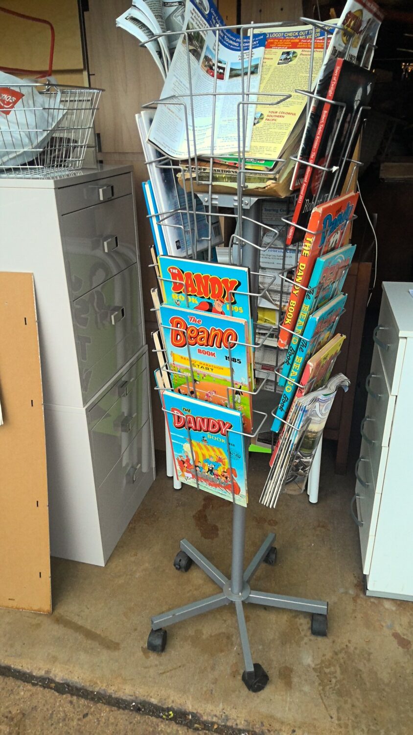 rotating magazine rack on wheels » Junk Skunk